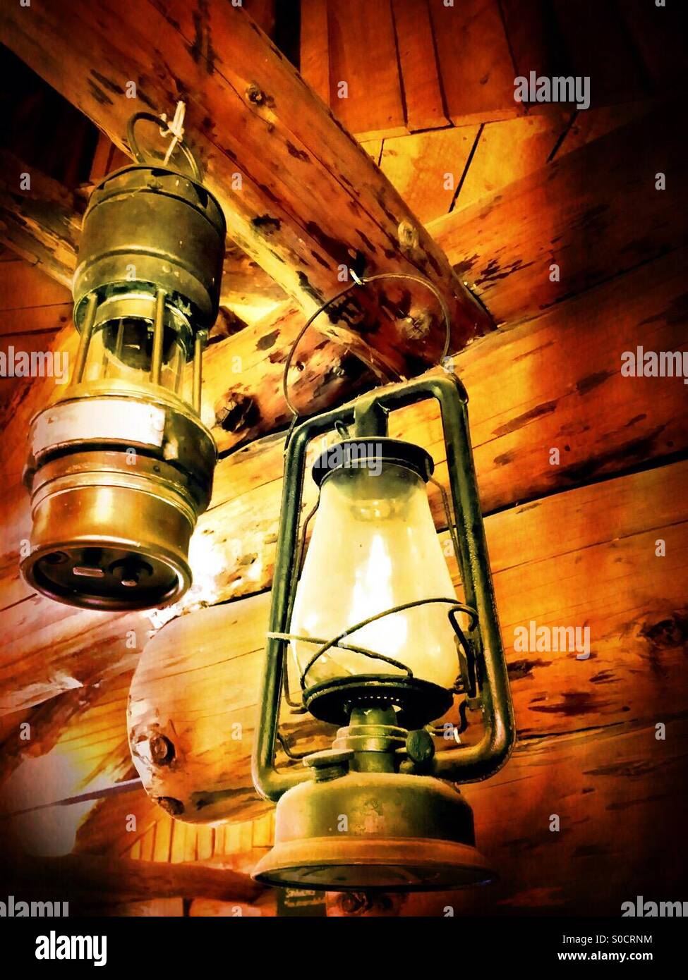 Miners Lights hanging in Log Cabin Stock Photo - Alamy