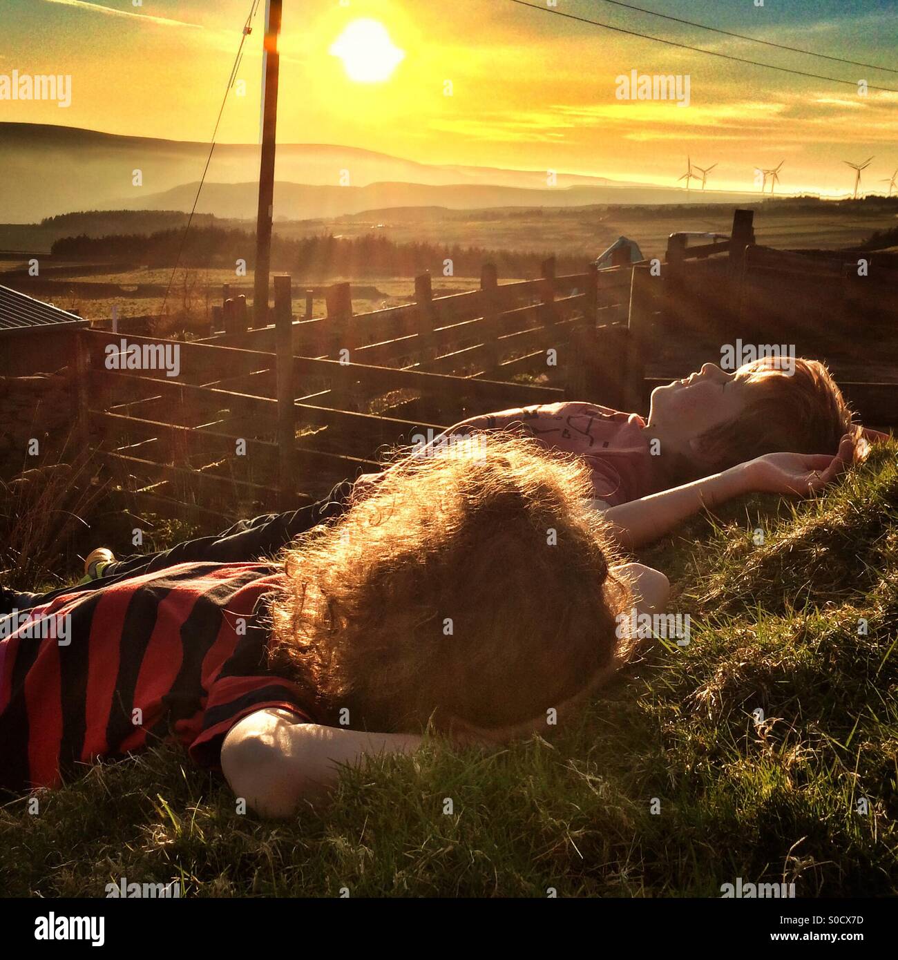 Children relaxing in the evening sun Stock Photo - Alamy