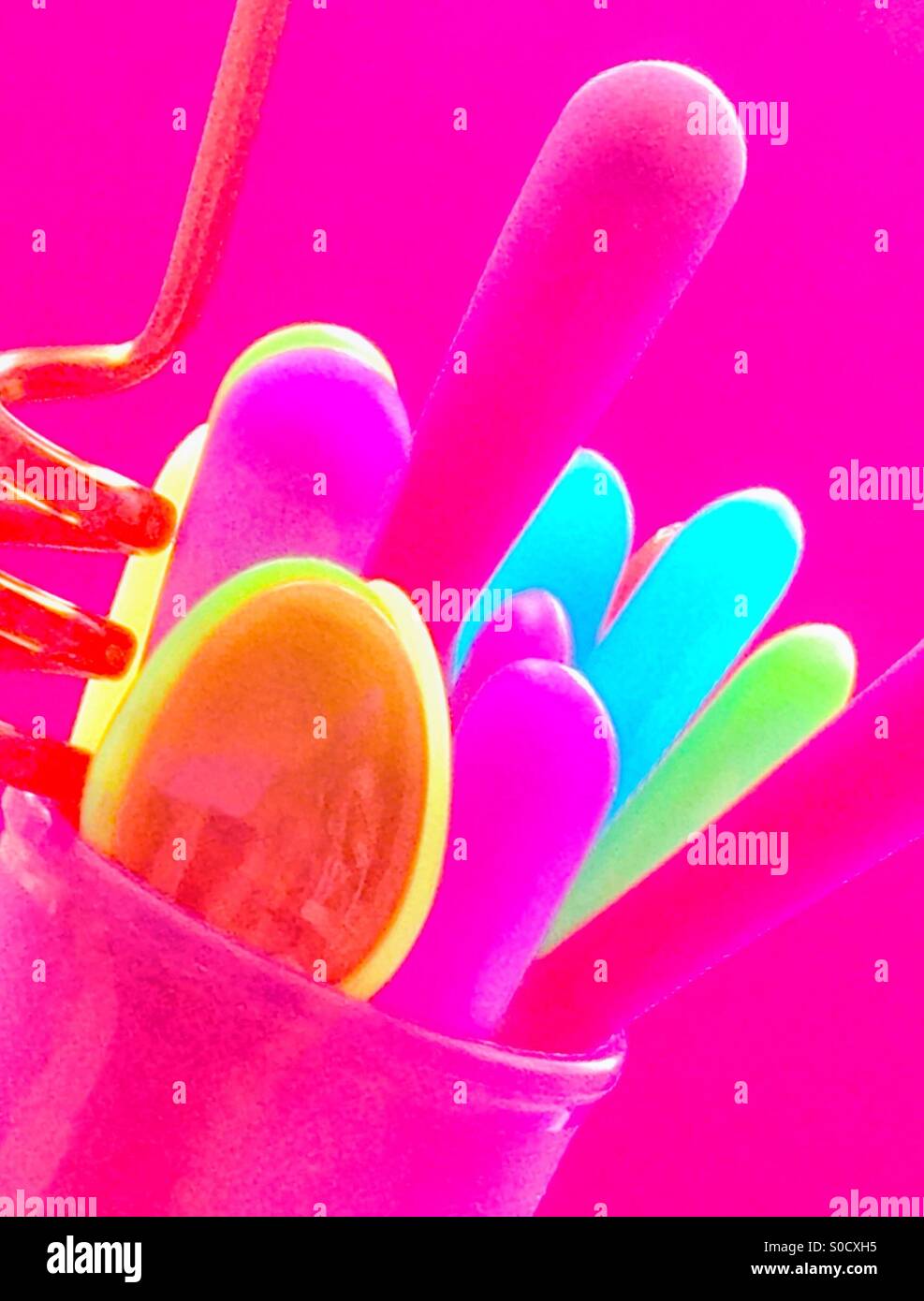 Brightly coloured kids utensils Stock Photo - Alamy