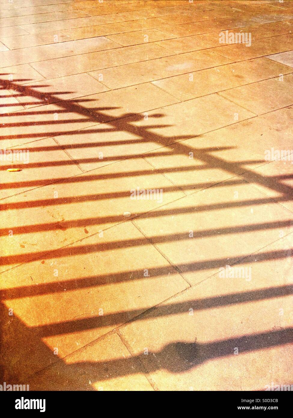 Shadow of railings on pavement Stock Photo - Alamy