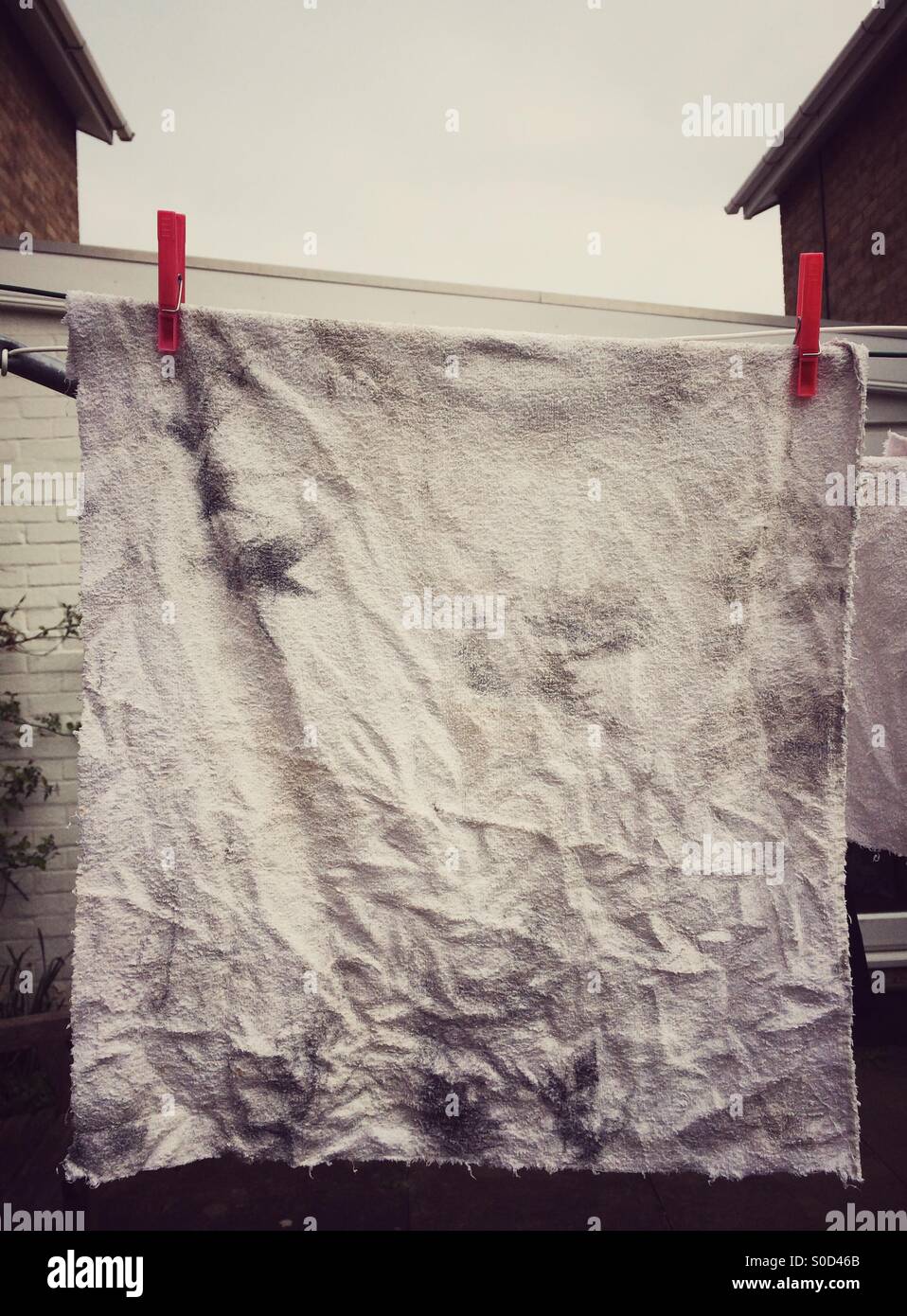 Washing powder fail. A dirty towel hangs on a washing line Stock Photo ...