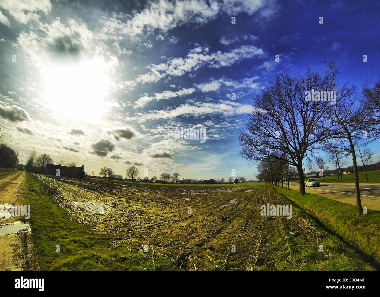 Sunset over farmland inbetween a path And a road Stock Photo - Alamy