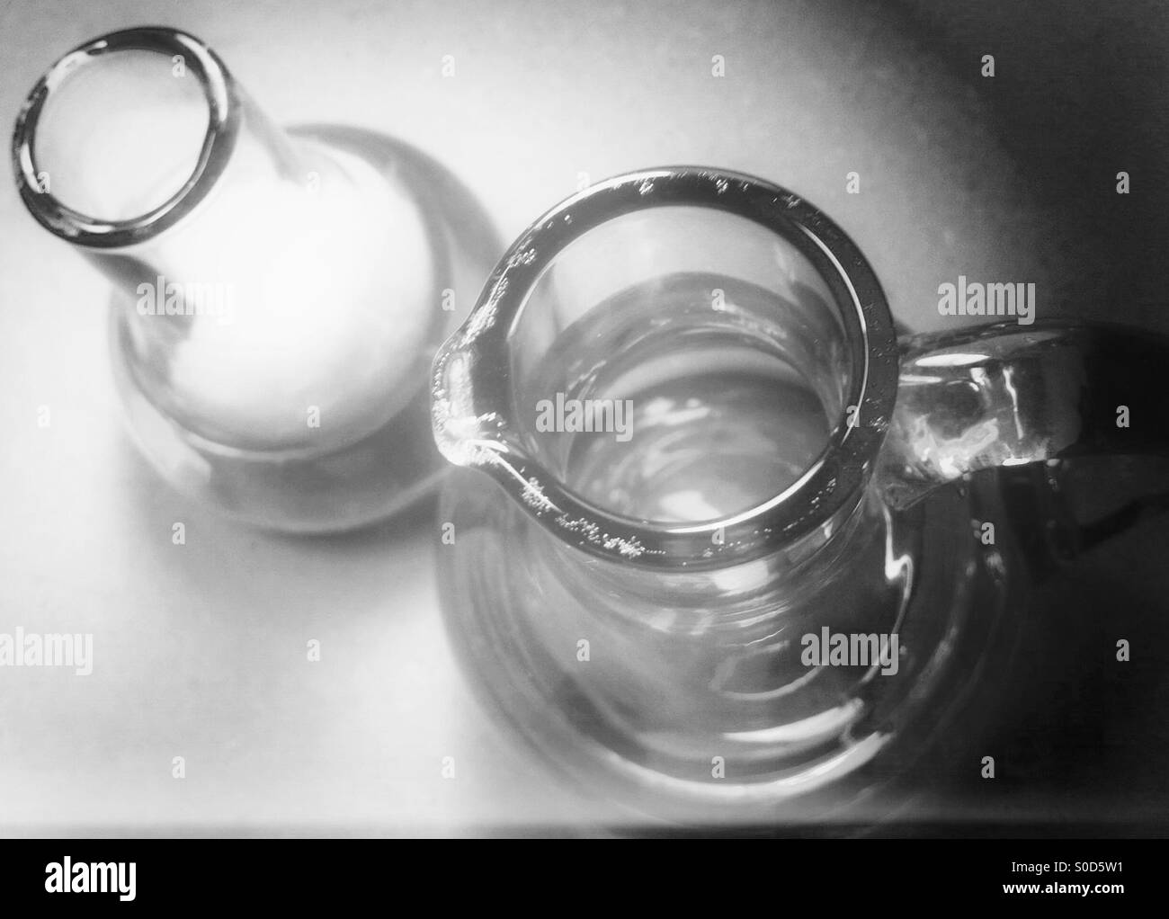 glass jars on a bright surface - black and white still life Stock Photo ...