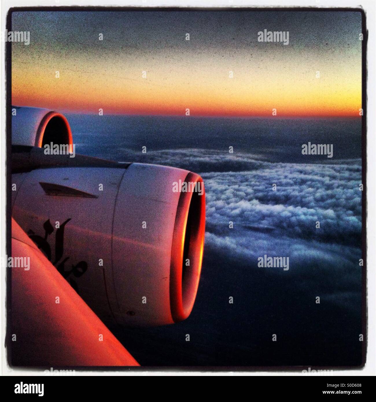 A passenger jet aircraft wing above the clouds on a flight from Dubai ...