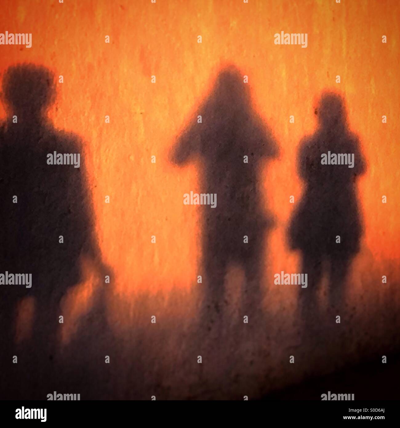 The shadows of three people cast on a wall, Vila Ruiva, Portugal Stock ...