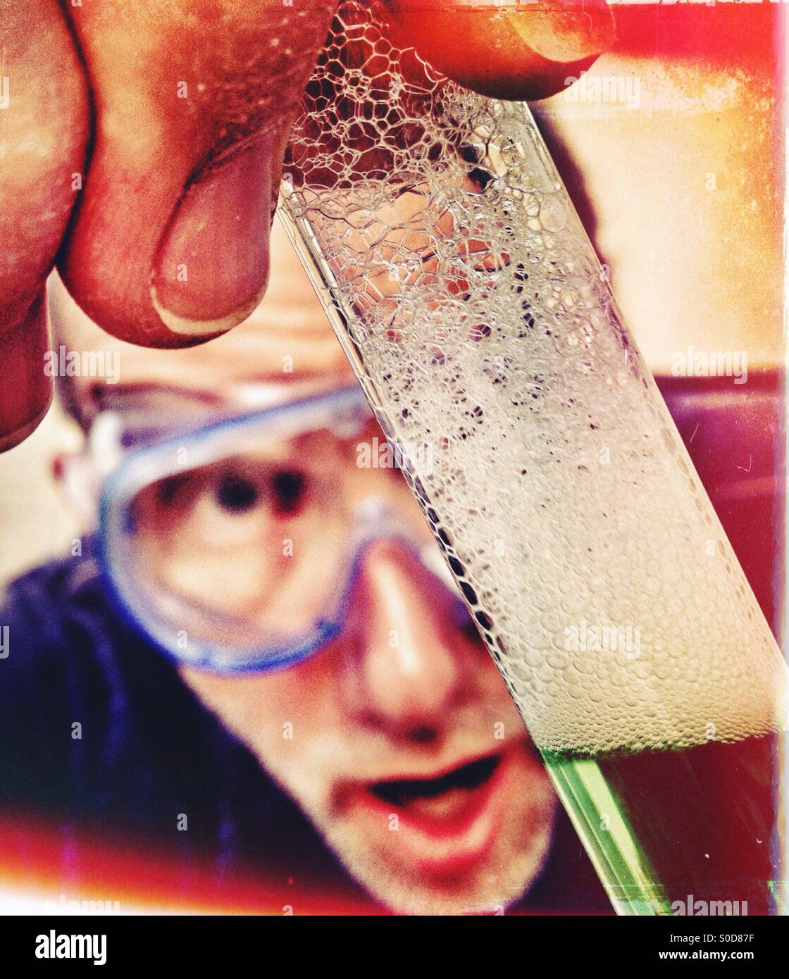 Scientist inspecting reaction in test tube Stock Photo - Alamy