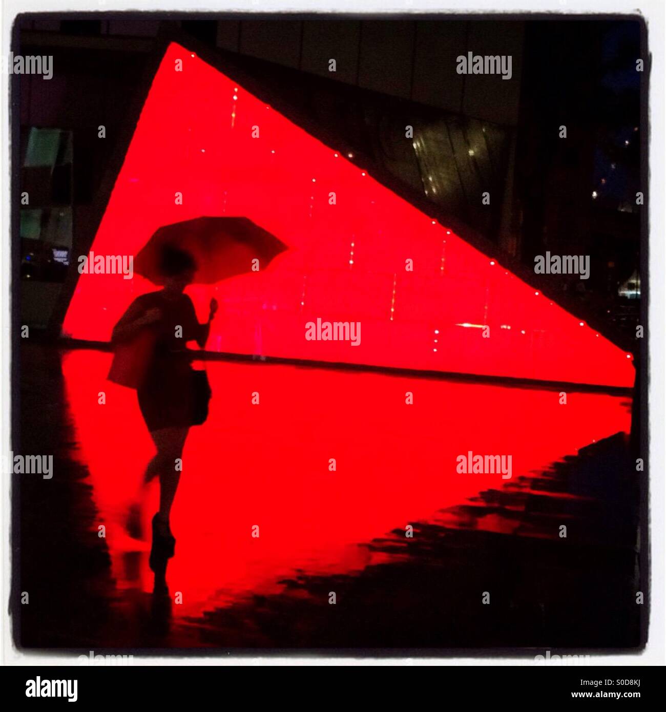 A commuter walks through the rain in the Central Business District in ... A commuter walks through the rain in the Central Business District in ...