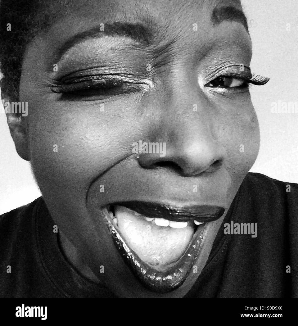 Black lady winking Stock Photo - Alamy