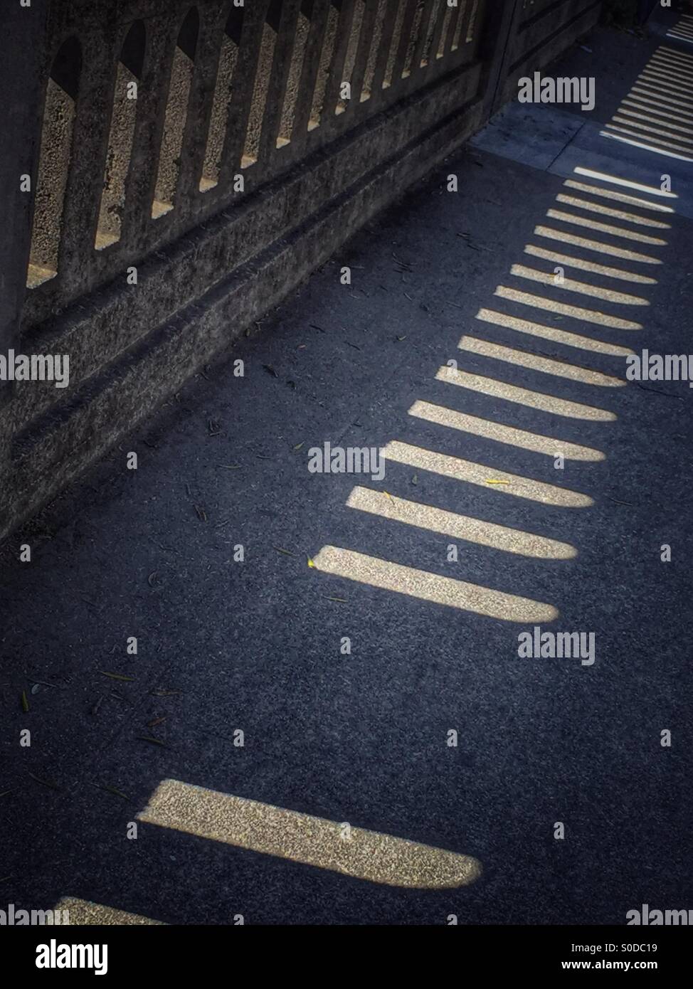 Light shining through onto asphalt sidewalk in San Francisco Stock ...