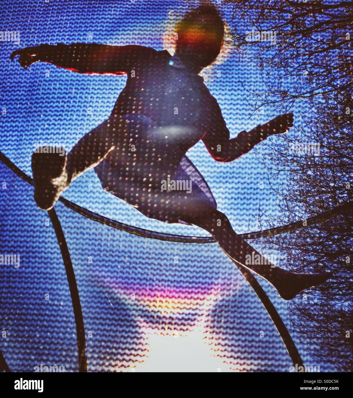 Young girl jumping on trampoline Stock Photo - Alamy