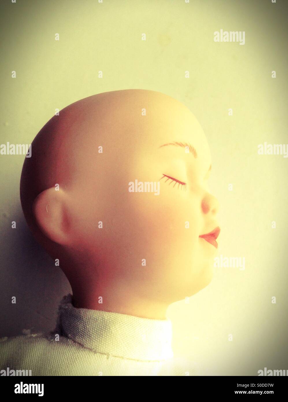 A close-up profile of a bald headed doll Stock Photo - Alamy