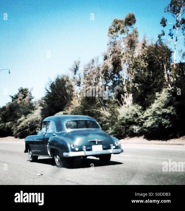 Vintage blue car on road Stock Photo - Alamy