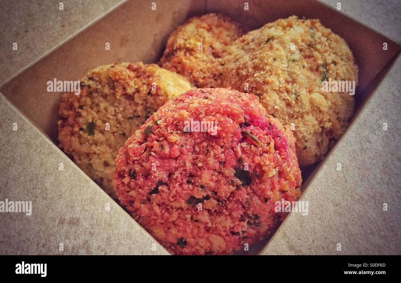 A selection of different flavoured handmade fish cakes in a cardboard ...