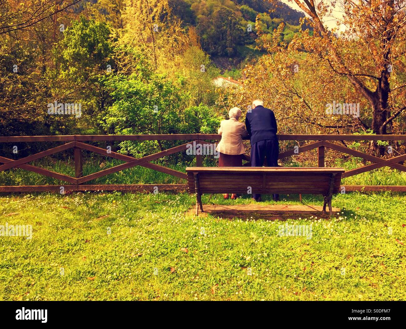 Man looking over fence woman hi-res stock photography and images - Alamy