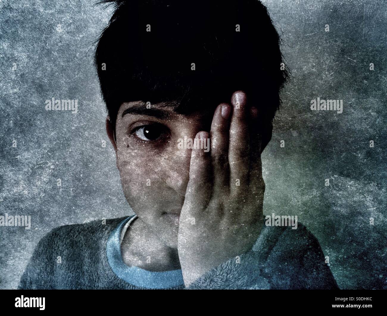 Scared boy hiding face with hand Stock Photo - Alamy
