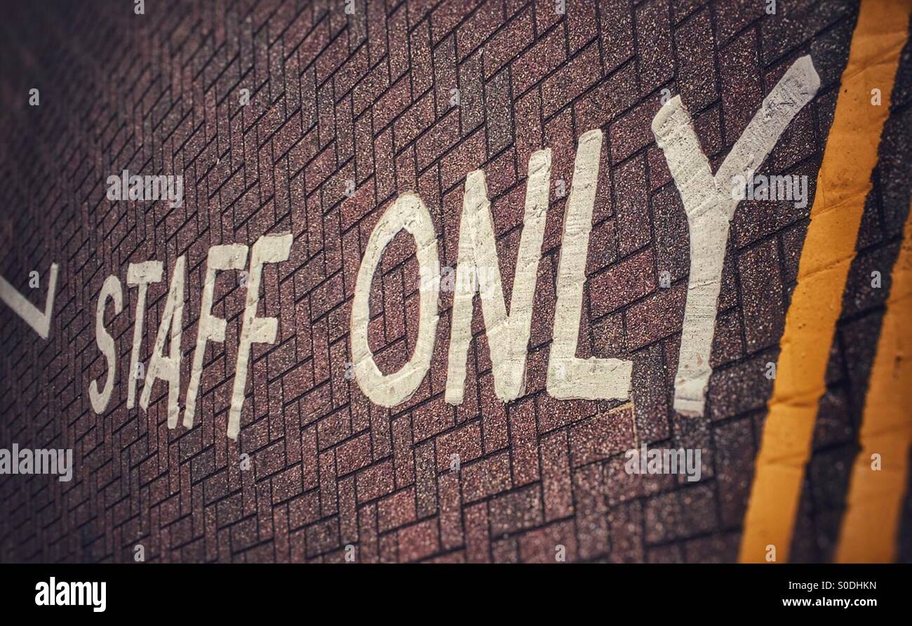 'Staff only' road marking with a double yellow line Stock Photo - Alamy