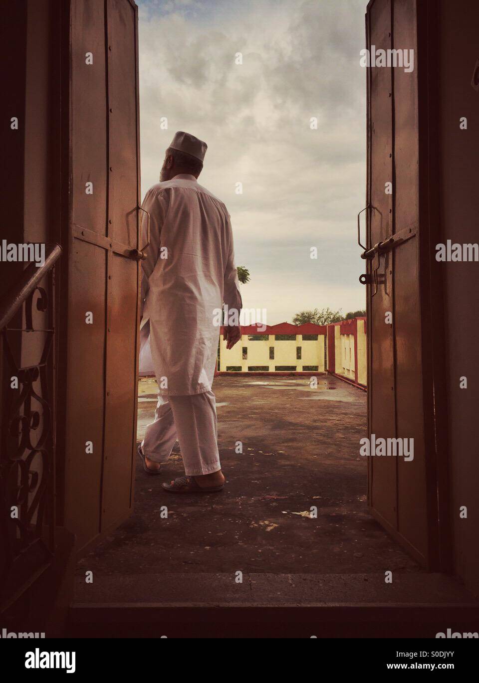 Man walking out of the house Stock Photo - Alamy