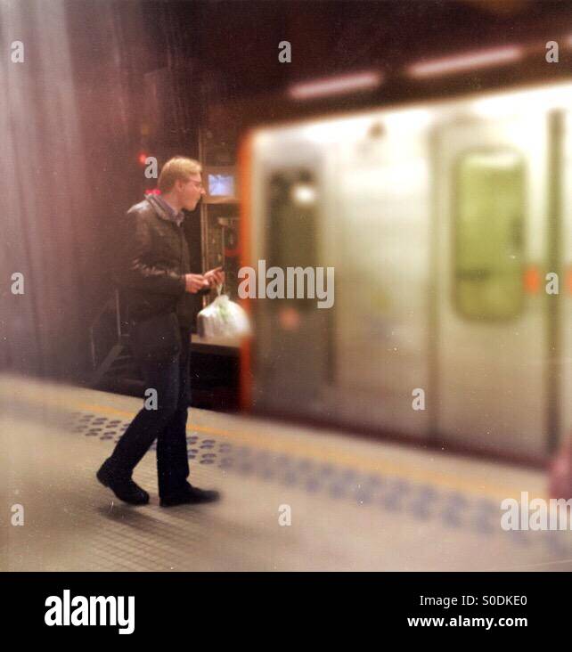 Man walking to embark into metro wagon in subway station Stock Photo ...