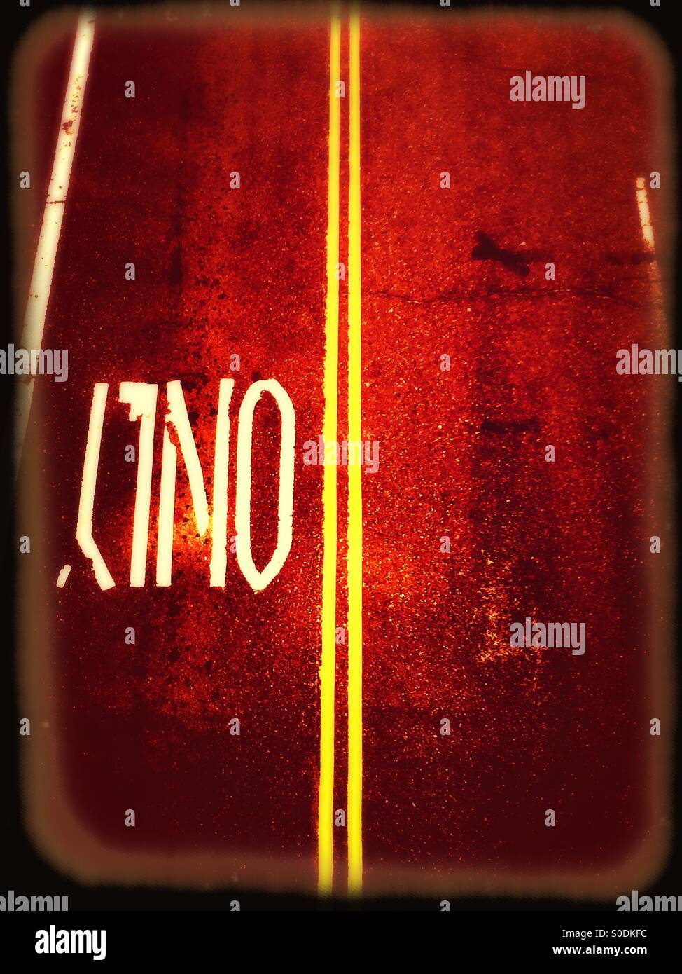 Two way city street with double yellow line and only sign Stock Photo ...