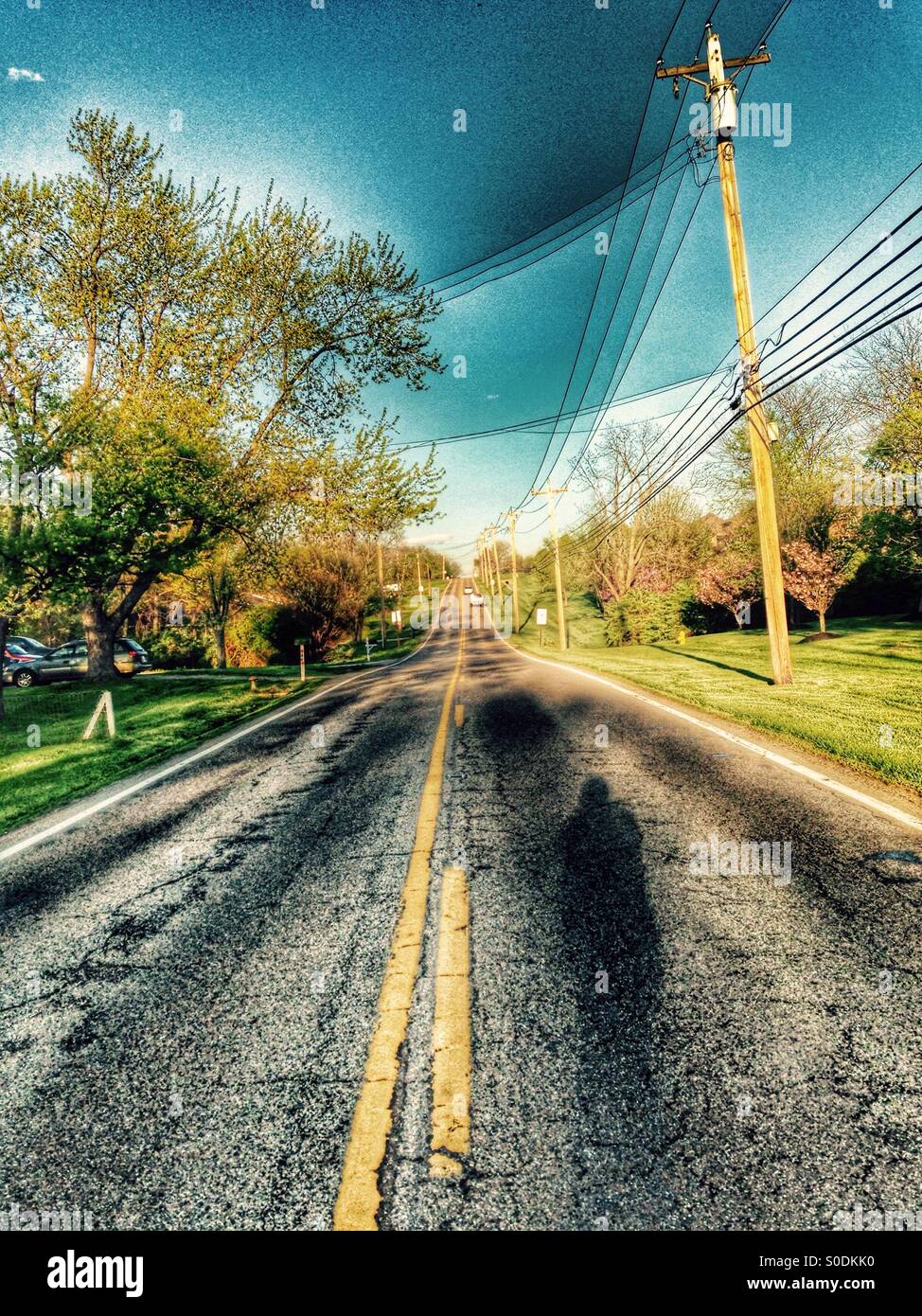 A shadow casted on a long road (1 Stock Photo - Alamy