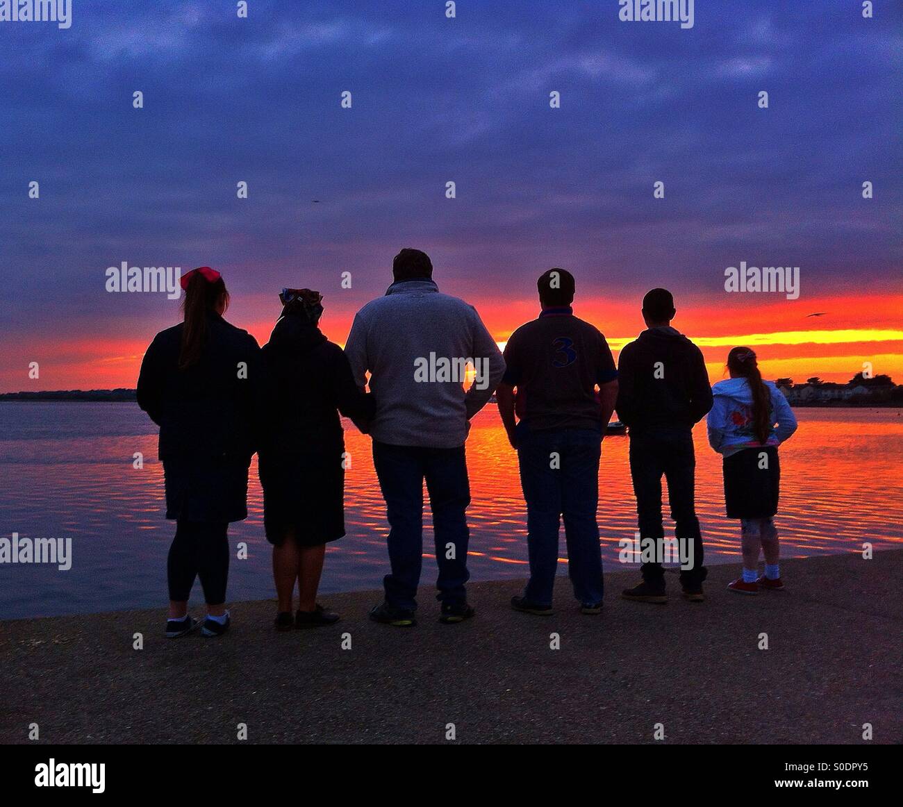 Family watching sunset hi-res stock photography and images - Alamy