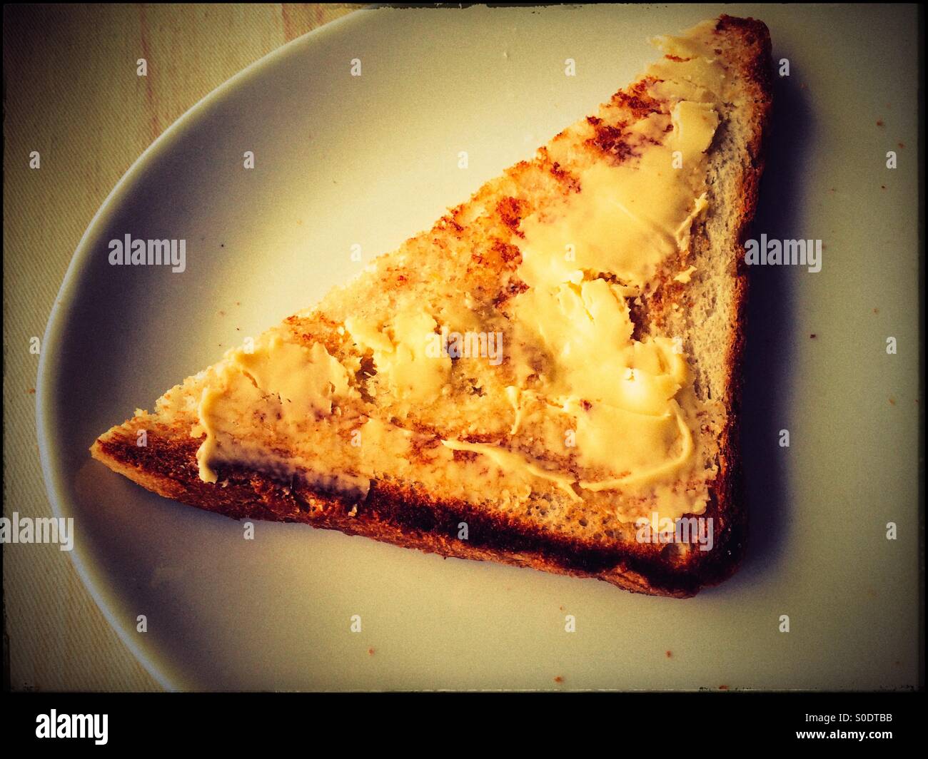 Piece of buttered toast Stock Photo - Alamy