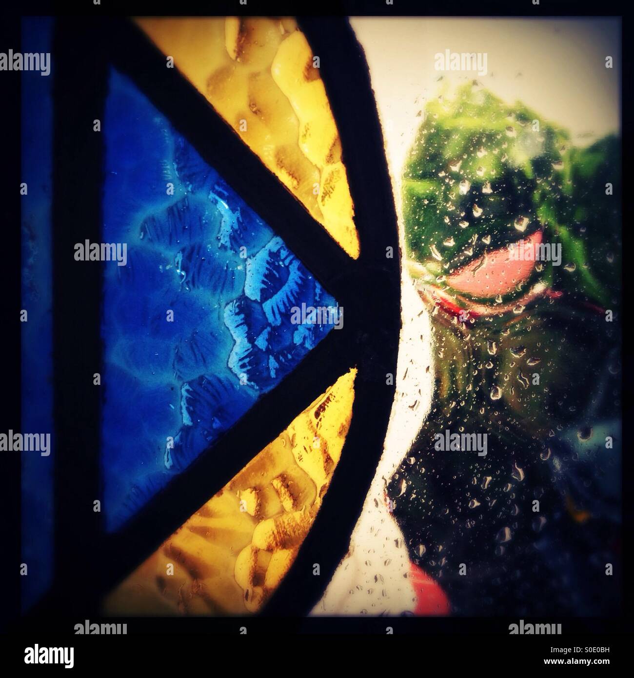 Rain falling on stained glass window Stock Photo - Alamy