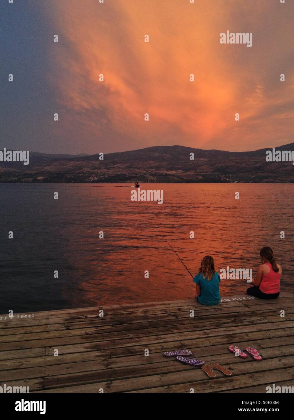 Girls fishing at sunset Stock Photo - Alamy