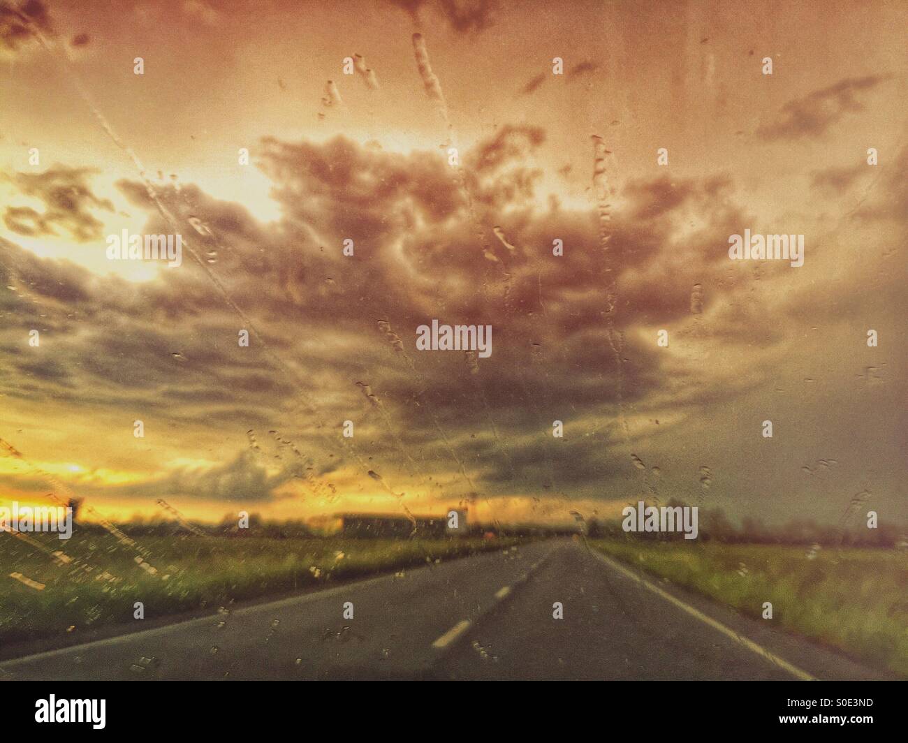 Rainy sunset on the road Stock Photo - Alamy
