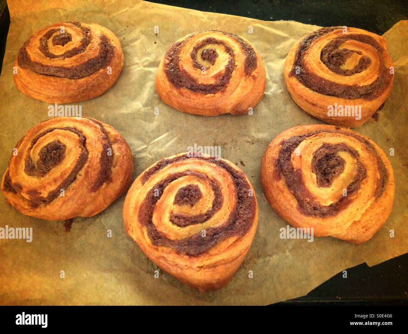 Cinammon Swirls on brown paper Stock Photo - Alamy