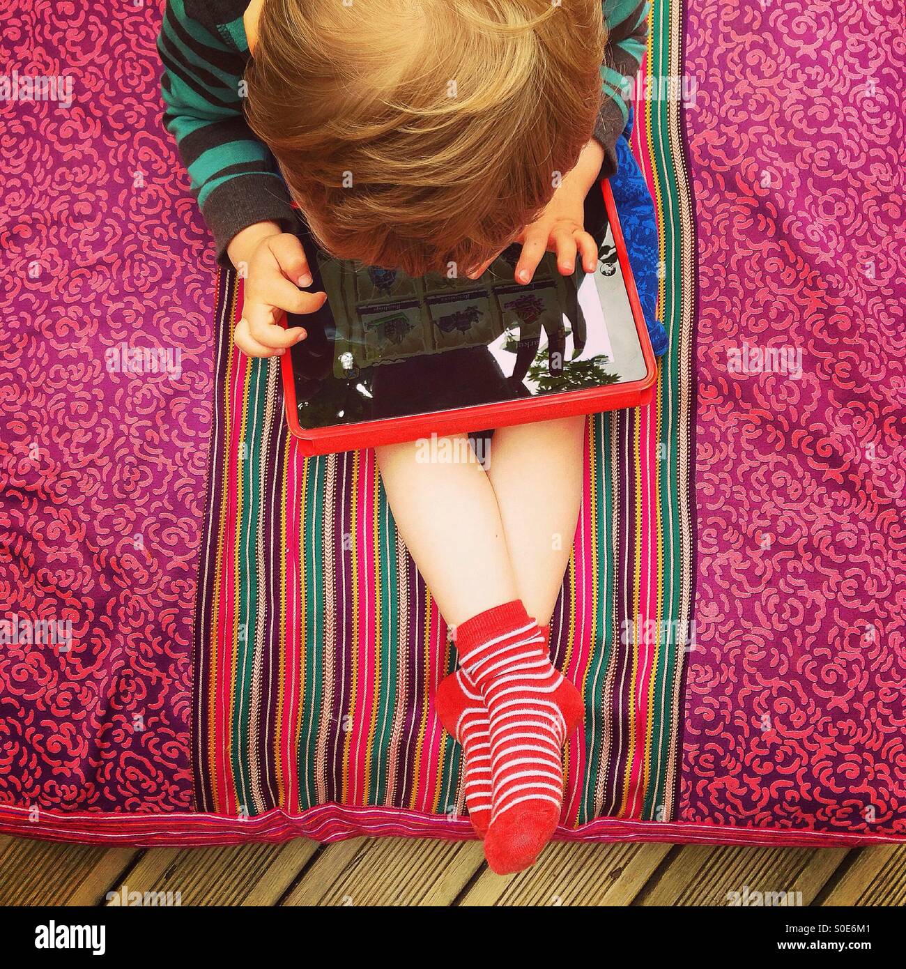 Young Boy playing on a Tablet Stock Photo - Alamy