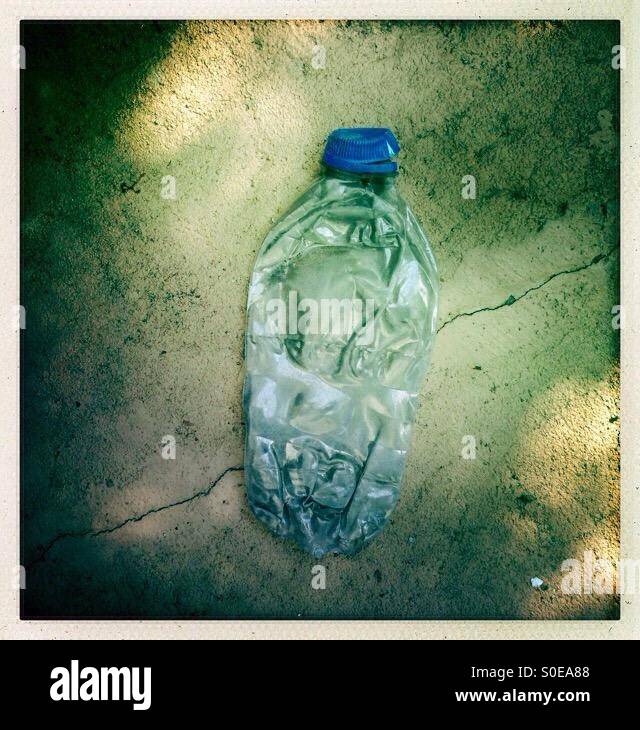 Crushed plastic water bottle, litter Stock Photo - Alamy