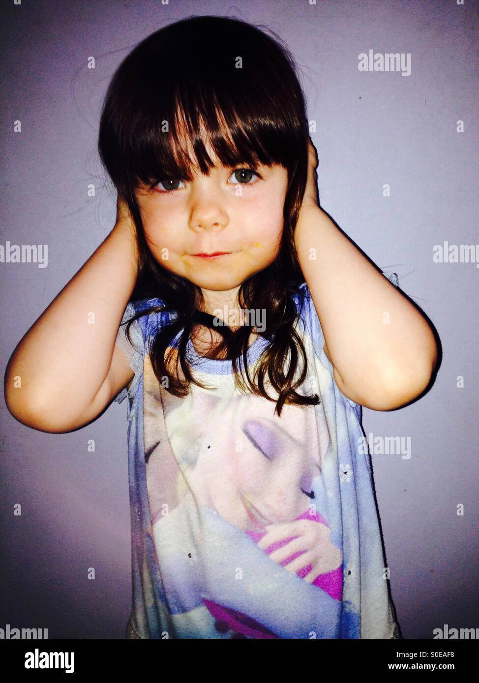 Girl holding hands over her ears hi-res stock photography and images ...