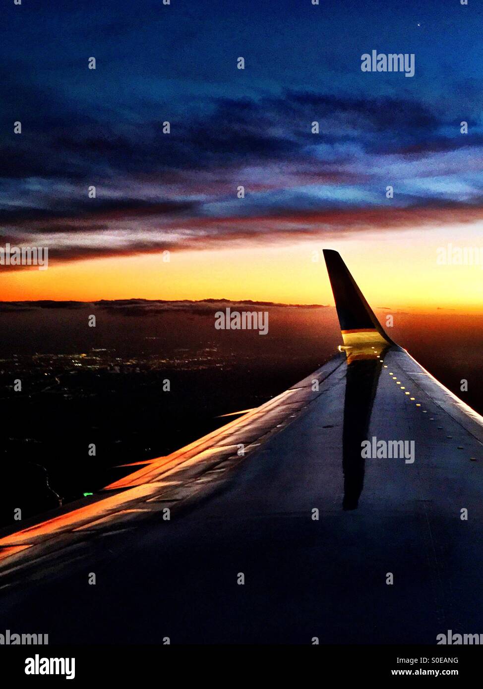 Wing of plane in sunset hi-res stock photography and images - Alamy