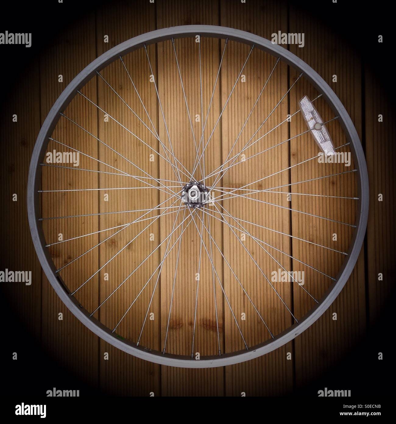 Bike wheel on decking with vignette Stock Photo - Alamy