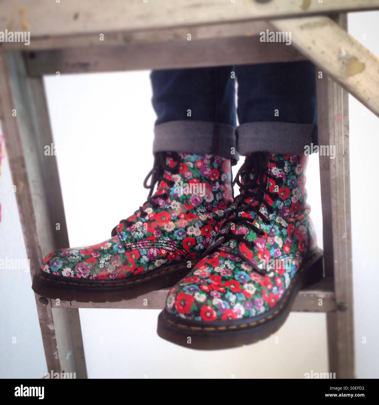 Boots on ladder Stock Photo - Alamy