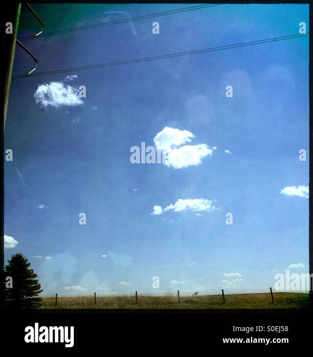 Clouds and blue sky through polarised car window Stock Photo - Alamy