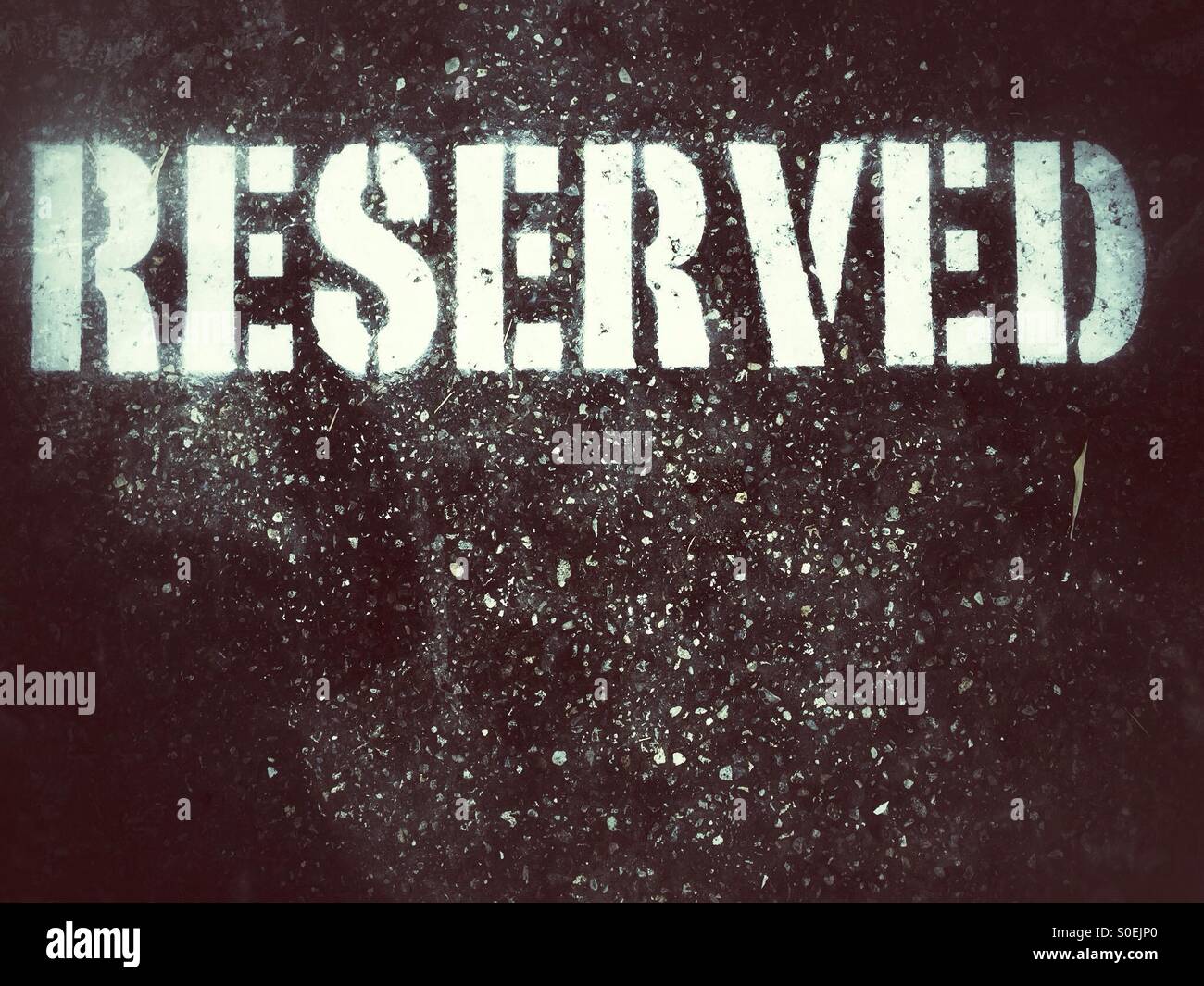 Word "reserved" on a asphalt Stock Photo - Alamy
