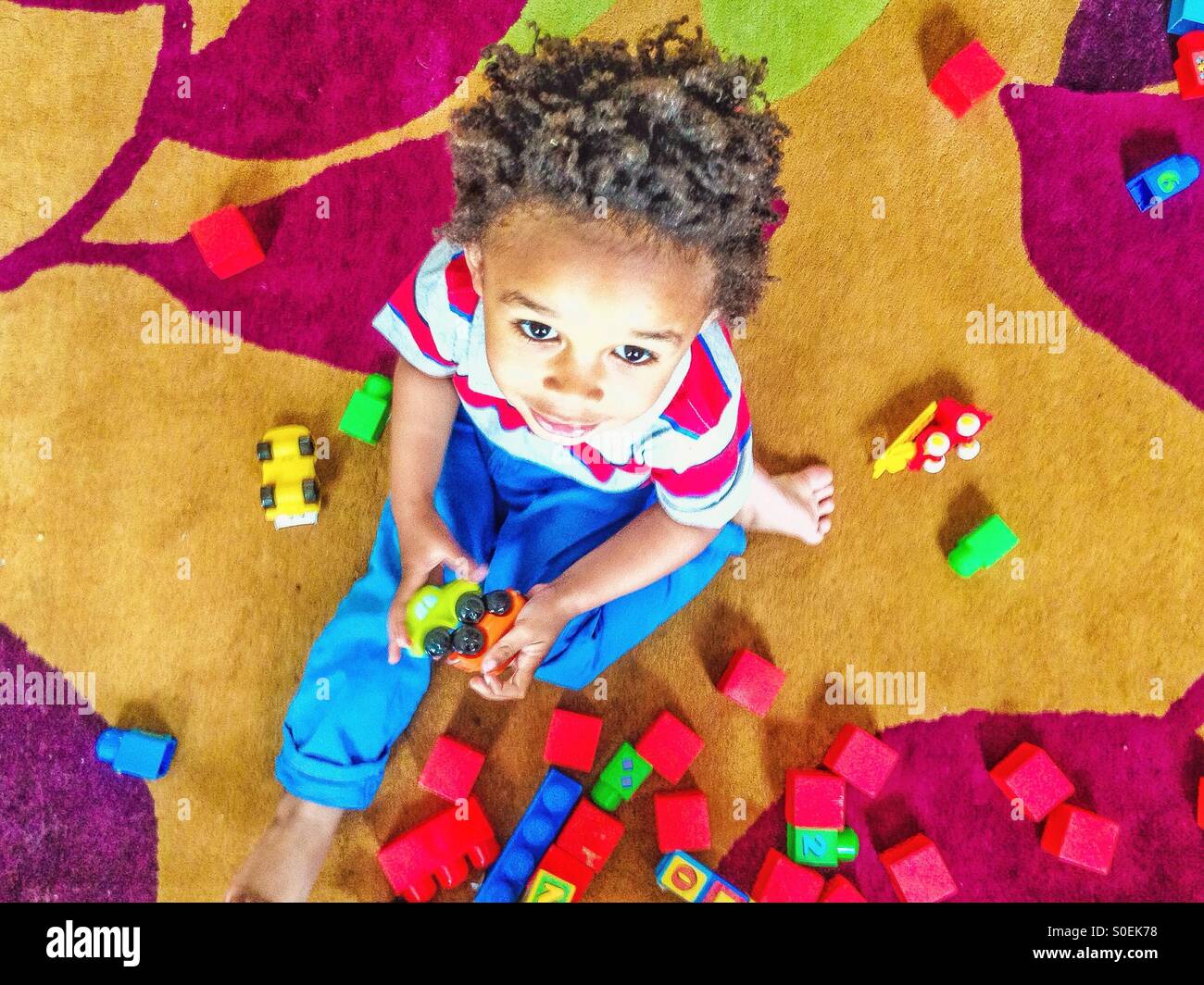 A little boy plays with his toys Stock Photo - Alamy