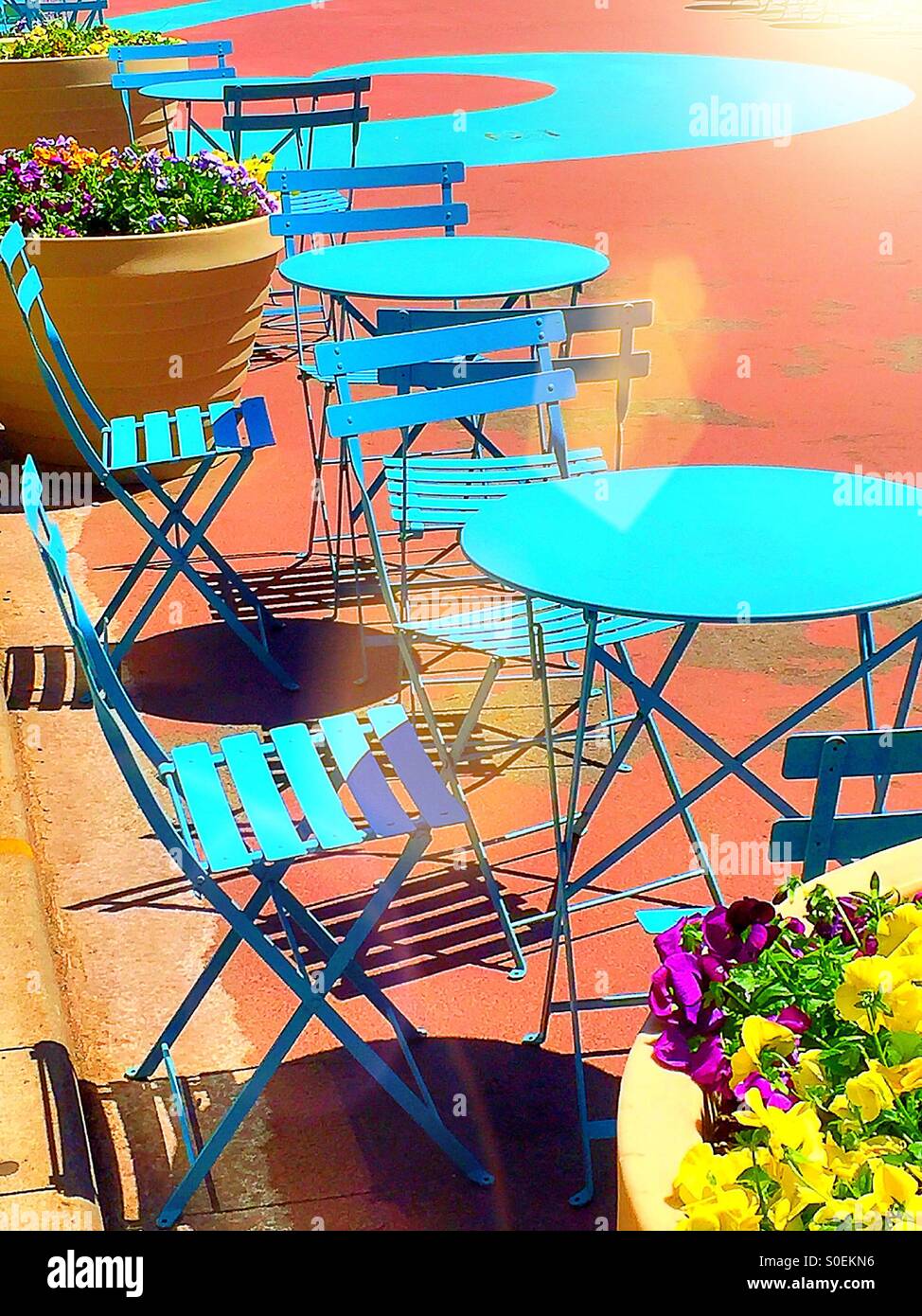 Outside patio table and chairs with flowers Stock Photo - Alamy