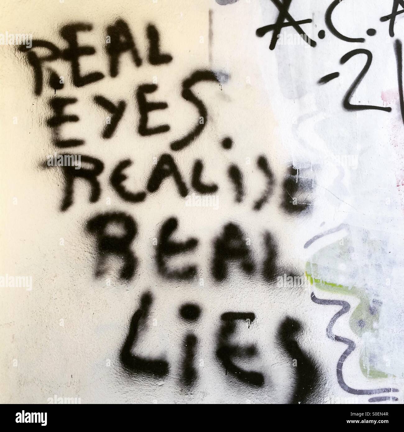Real eyes realise real lies. Clever wordplay Stock Photo - Alamy