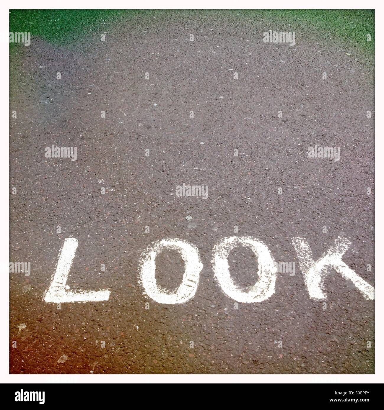 Street sign on asphalt in London UK the word look Stock Photo - Alamy