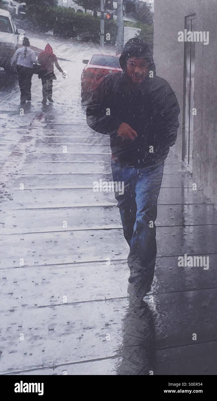 A man running for shelter from a rainstorm Stock Photo - Alamy