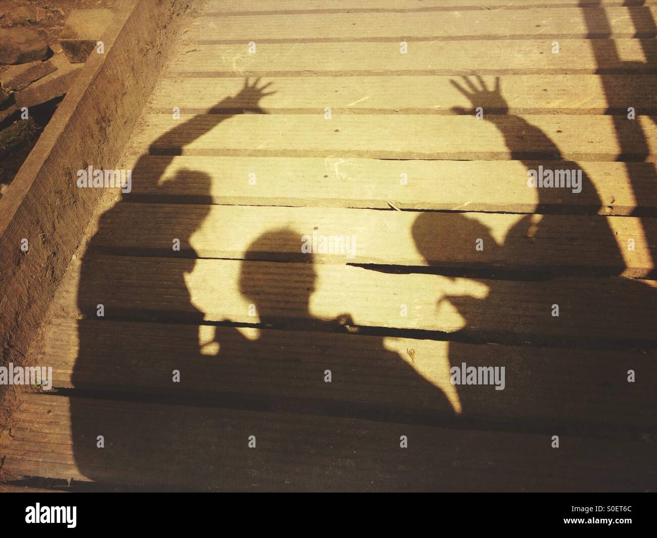 Shadows of three people Stock Photo - Alamy