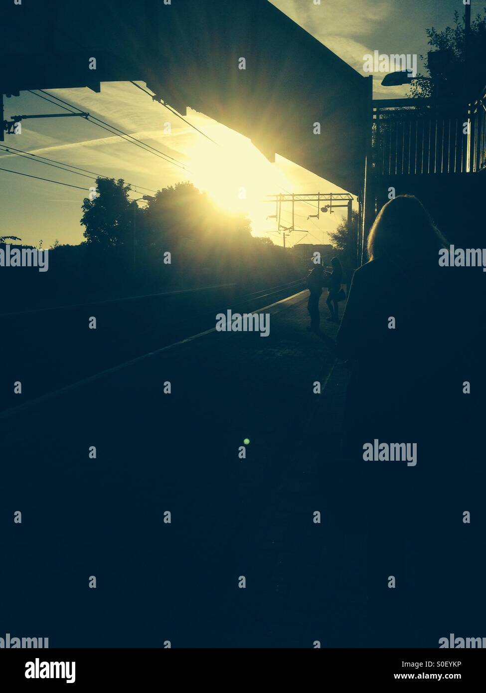 Early morning commuters waiting for the train Stock Photo - Alamy