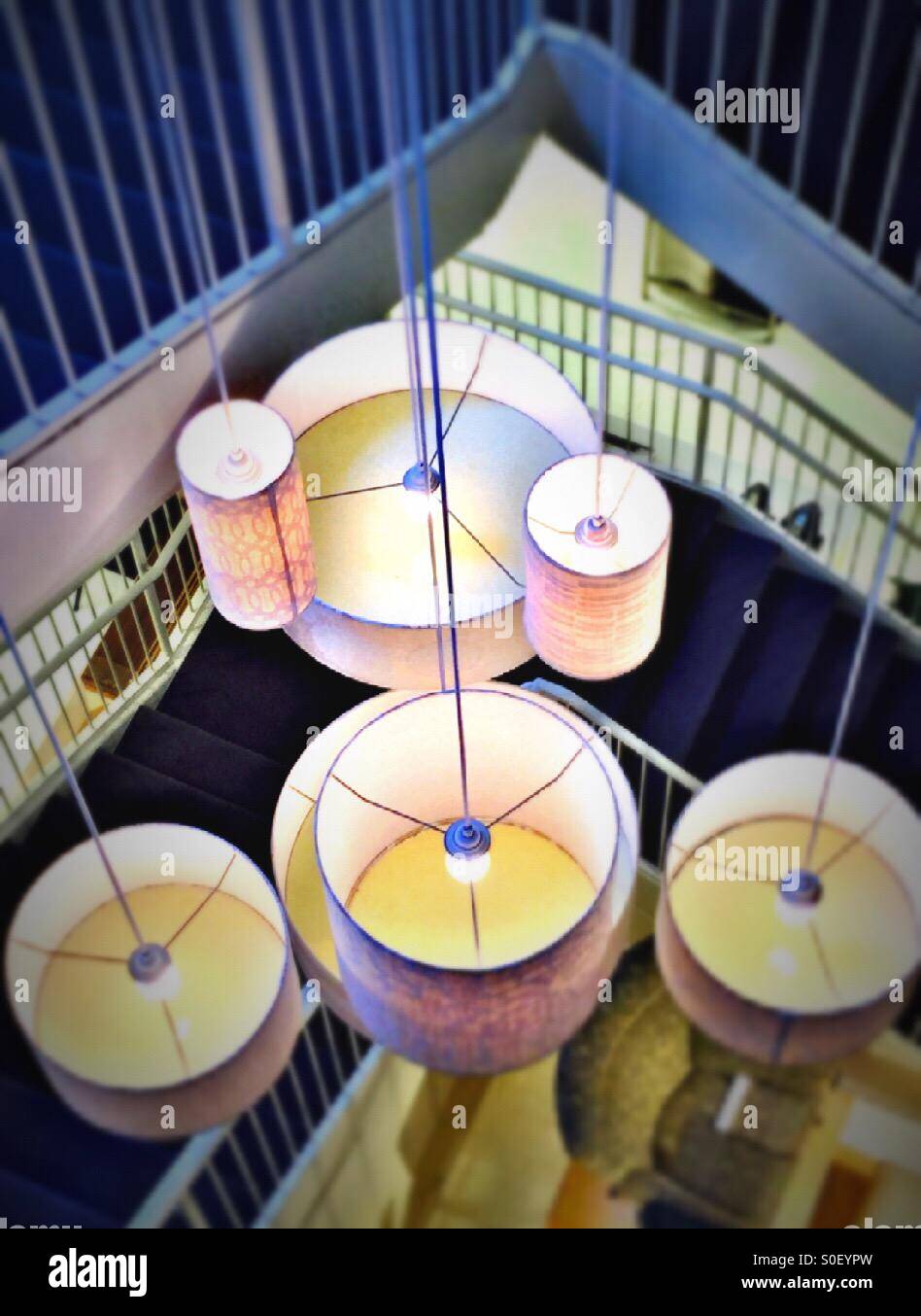 Hanging lights in store staircase Stock Photo - Alamy