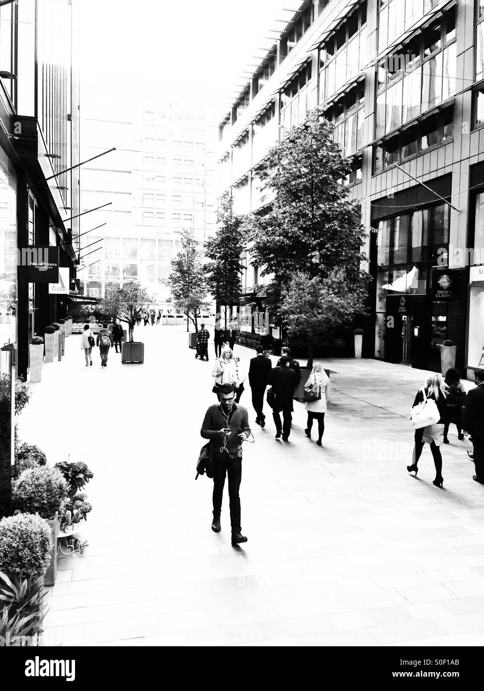 People walking through a city Stock Photo - Alamy