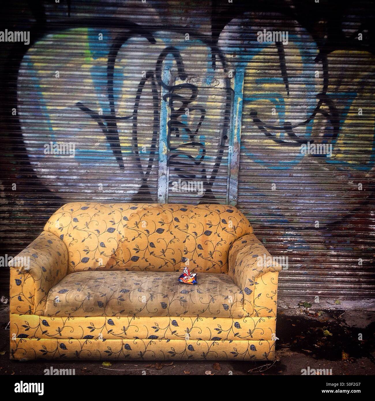 An abandoned sofa in a street painted with graffiti in Colonia Roma ...