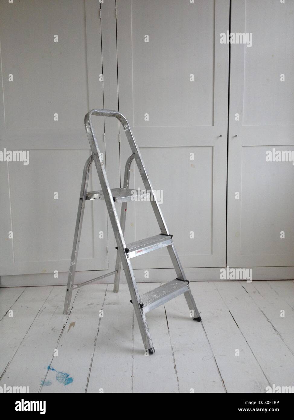 Step ladder in white room Stock Photo - Alamy