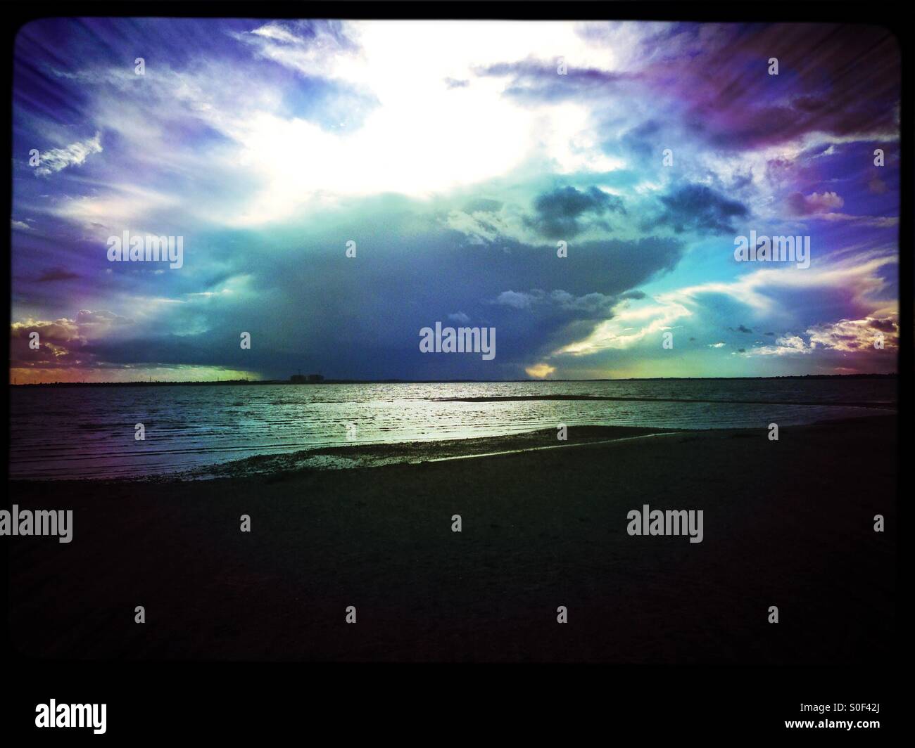 The sun breaking through a storm cloud Stock Photo - Alamy